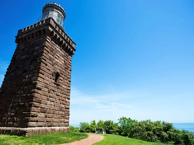That brownstone tower standing sentinel against blue sky? Pure architectural poetry from another era entirely.