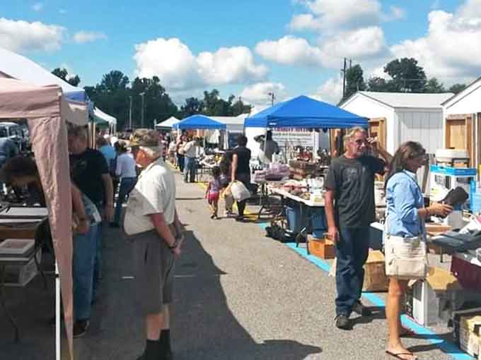 Blue canopies dot the landscape like cheerful umbrellas, sheltering tables packed with weekend discoveries waiting to happen.