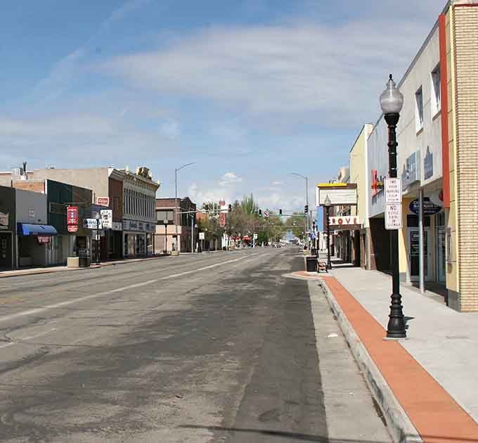 Classic storefronts line Main Street under endless blue skies, proving small-town charm still exists in Colorado.