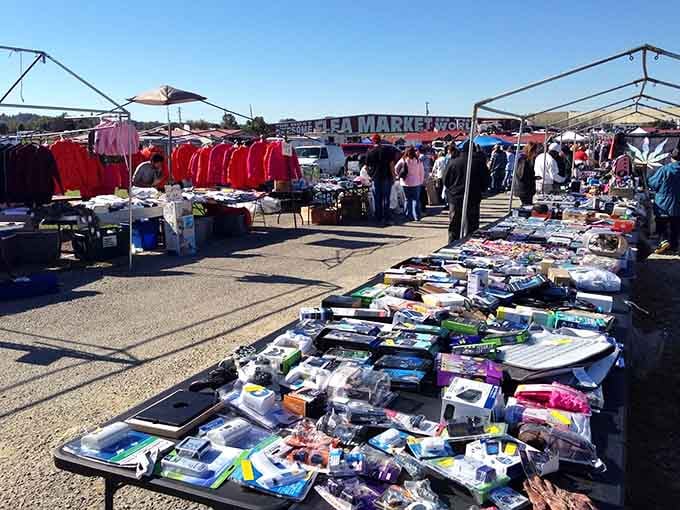 Rows of vendors stretch endlessly under white canopies, offering everything from red jackets to household essentials galore.