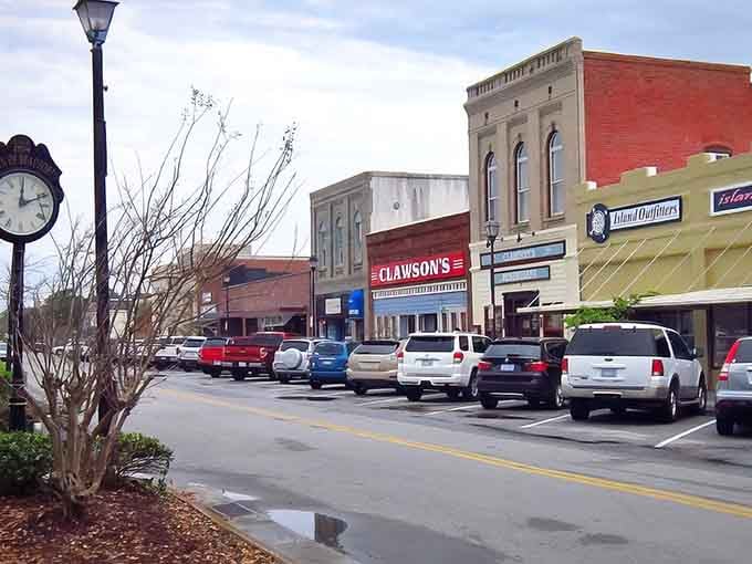 That vintage street clock stands guard while historic brick buildings whisper tales of centuries past to passing visitors.