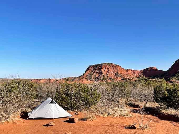 That lone tent beneath rust-colored cliffs proves the best seats in Texas don't require reservations or crowds.