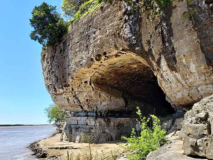 The cave opening frames the Ohio River like a natural picture window designed by ancient waters and time.