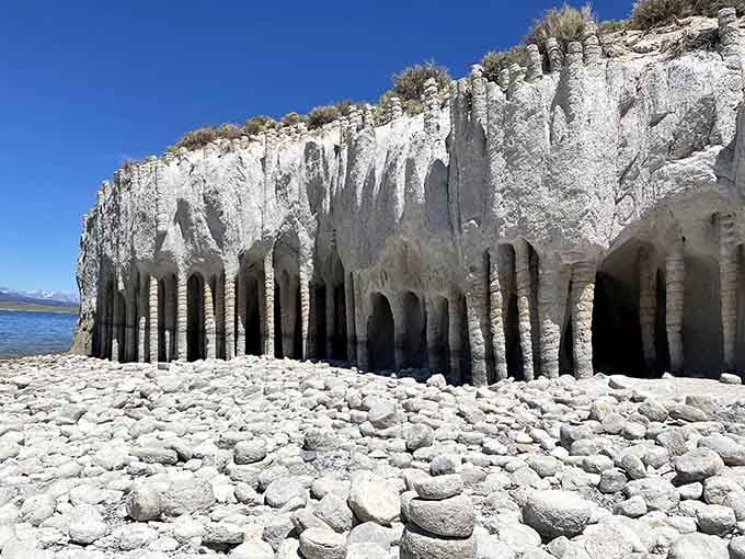 These towering stone pillars stand guard along the water's edge like a frozen army from another world.