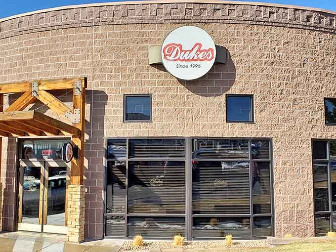 The red Duke's sign against sunny brick promises the kind of meal that makes you cancel your dinner plans.