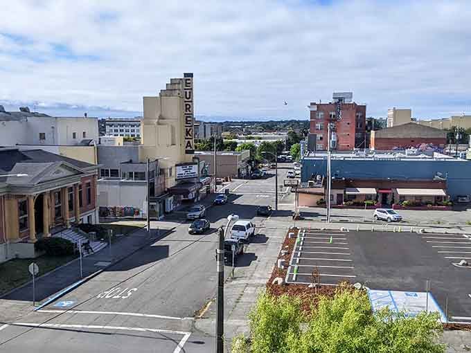 The Eureka sign towers over downtown where historic buildings meet modern life in perfect harmony.