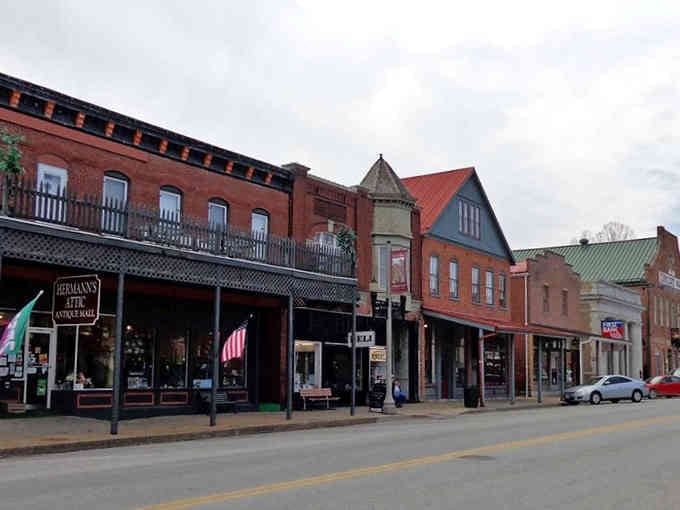 Iron balconies and vintage awnings create a streetscape that feels like stepping into a classic Western movie set.