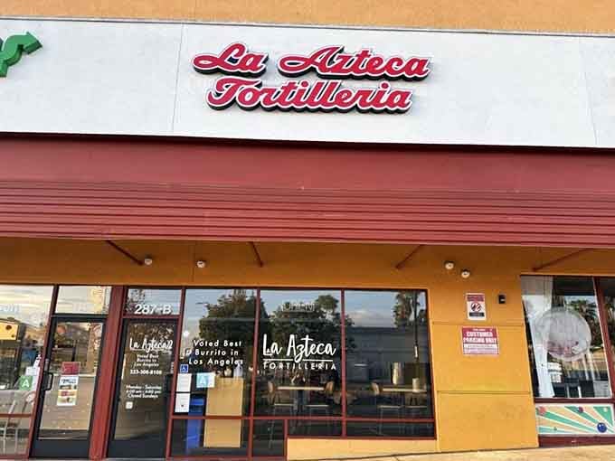 La Azteca's sunny yellow exterior promises what lies inside – tortilla perfection that would make your abuela weep with joy.