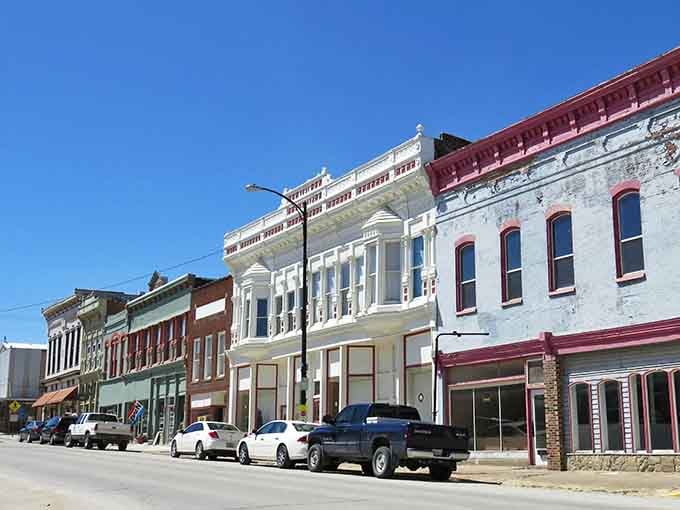 These colorful storefronts stand shoulder to shoulder like old friends, each one telling stories through weathered brick and vintage charm.