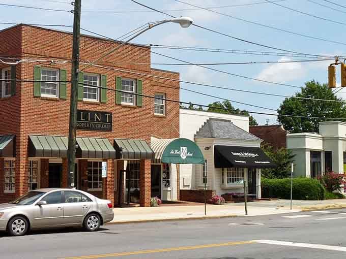 Tree-lined streets with local storefronts remind you that small-town shopping beats big-box stores every single time.