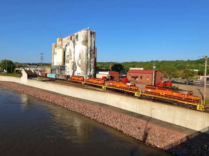 The Mississippi River flows past Mankato's industrial heritage, where trains and grain elevators create a uniquely Midwestern tableau that's both working landscape and accidental art.