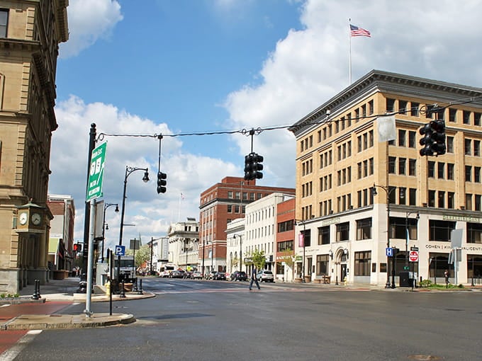 Blue skies frame downtown streets where architecture meets everyday life in perfect harmony.