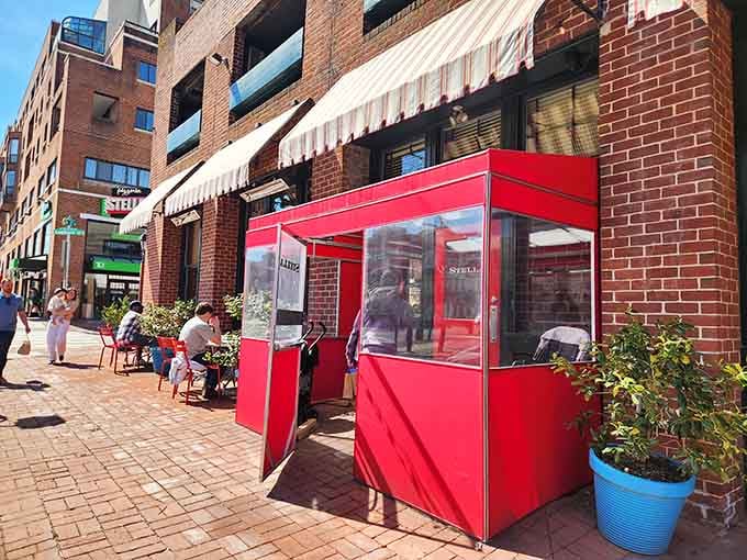 That bright red entrance isn't just eye-catching—it's a portal to wood-fired perfection that'll make your taste buds dance with joy.