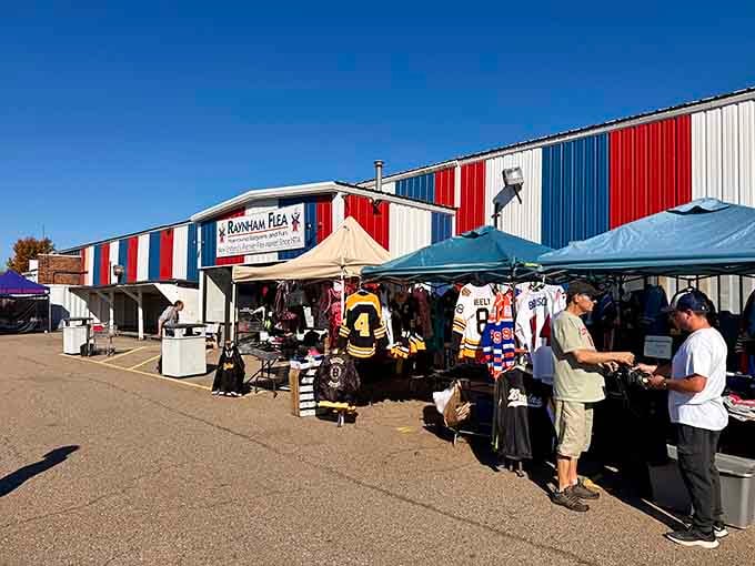 Outdoor vendors spread their treasures under blue skies while hockey jerseys hang like flags of New England pride.