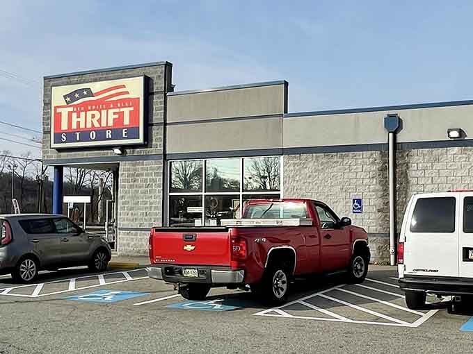 The patriotic sign stands proud against cloudy skies, beckoning bargain hunters to discover what's hiding on those racks.