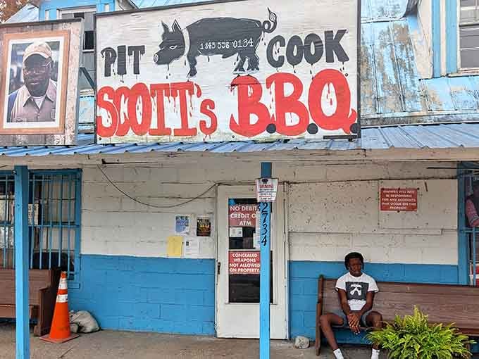 That hand-painted "PIT COOK" sign isn't just decoration &ndash; it's a promise of whole hog barbecue that's worth crossing state lines for.