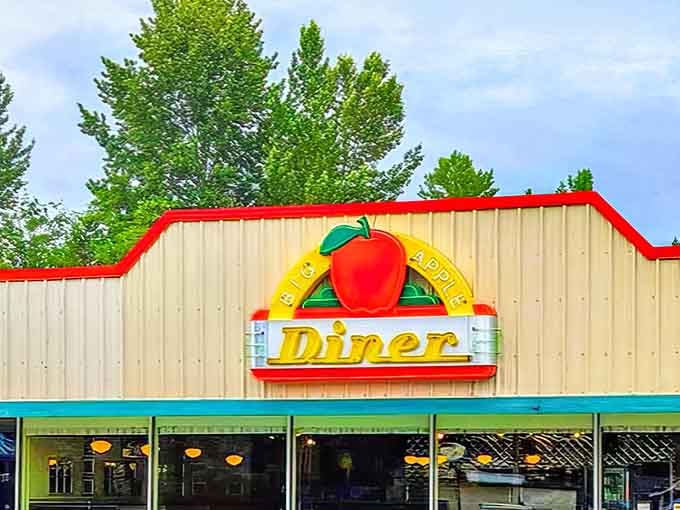 Nestled among green trees, this cheerful diner beckons hungry travelers with its bright, welcoming colors and promise.
