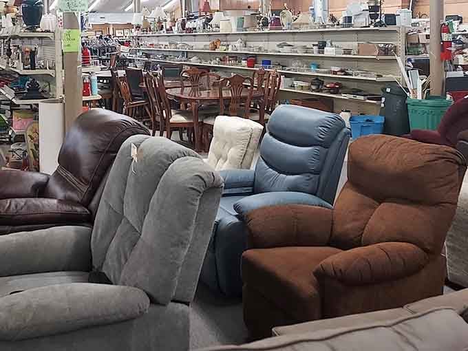 Recliners lined up like comfortable soldiers, ready to cradle weary shoppers in secondhand luxury.