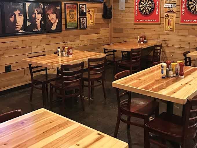 Wood paneling meets rock history where dartboards and Beatles faces create the perfect tavern vibe.