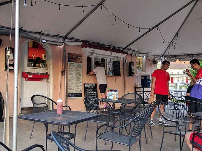 Alamo BBQ's order window framed perfectly, where culinary magic happens and hungry people find their salvation through smoke.
