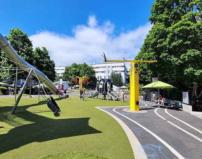 Modern playground design meets artistic vision where kids become tiny mountaineers conquering colorful geometric peaks daily.