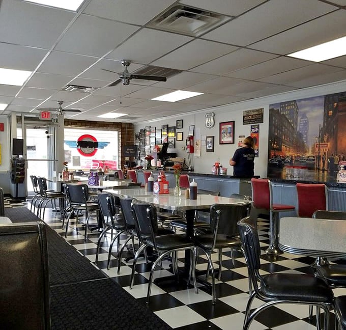 Black and white checkered floors meet red vinyl seats in a symphony of classic diner design that never goes out of style.