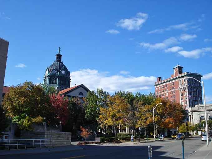 That courthouse dome rising above fall foliage proves architecture used to mean something beyond glass boxes and corporate blandness.