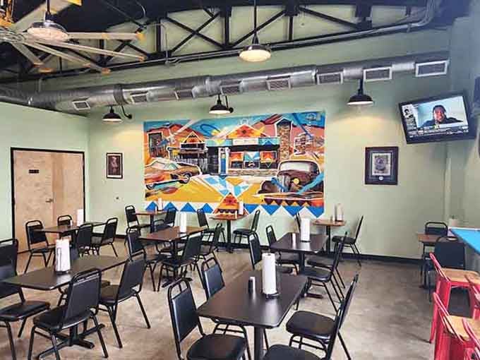 Step inside where colorful murals meet serious barbecue, proving art and appetite make beautiful partners together.