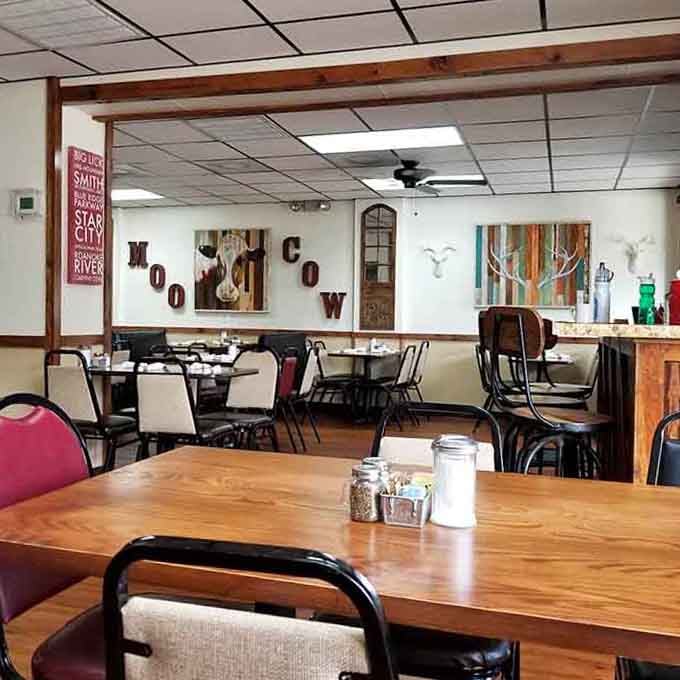 Inside, rustic wood beams and local art create the kind of welcoming atmosphere that makes strangers feel like regulars.