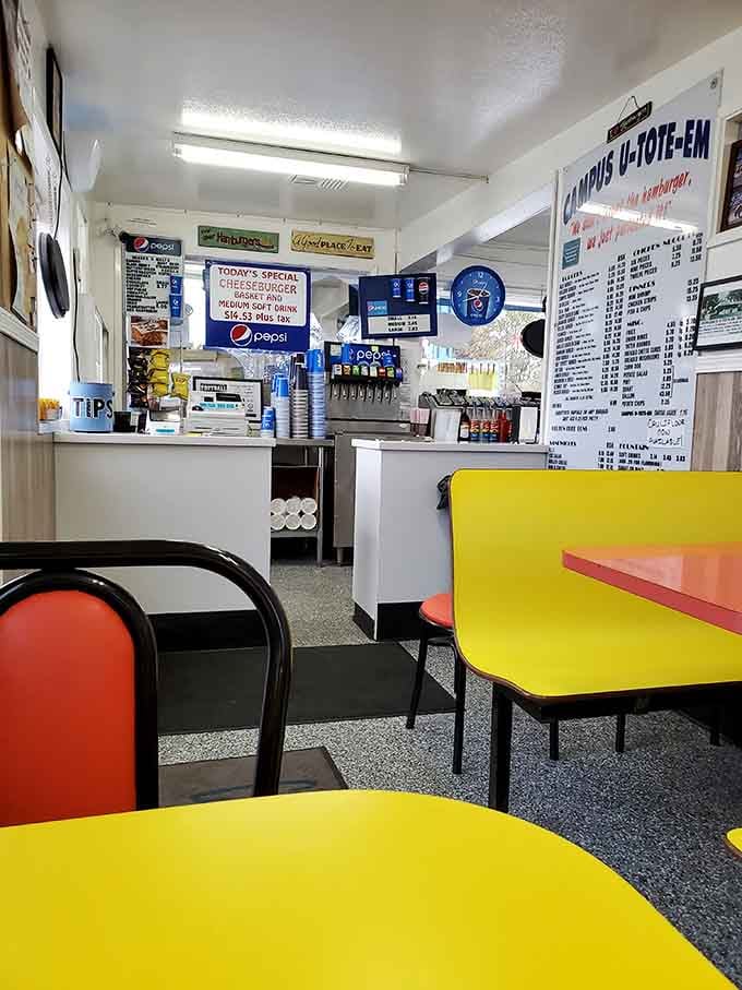 Step inside where bright yellow tables meet classic diner charm, proving that happiness comes in primary colors and paper-wrapped burgers.