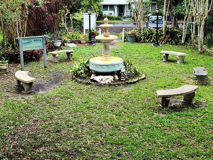 This tranquil meditation garden invites contemplation, complete with fountain and stone benches for peaceful reflection moments.
