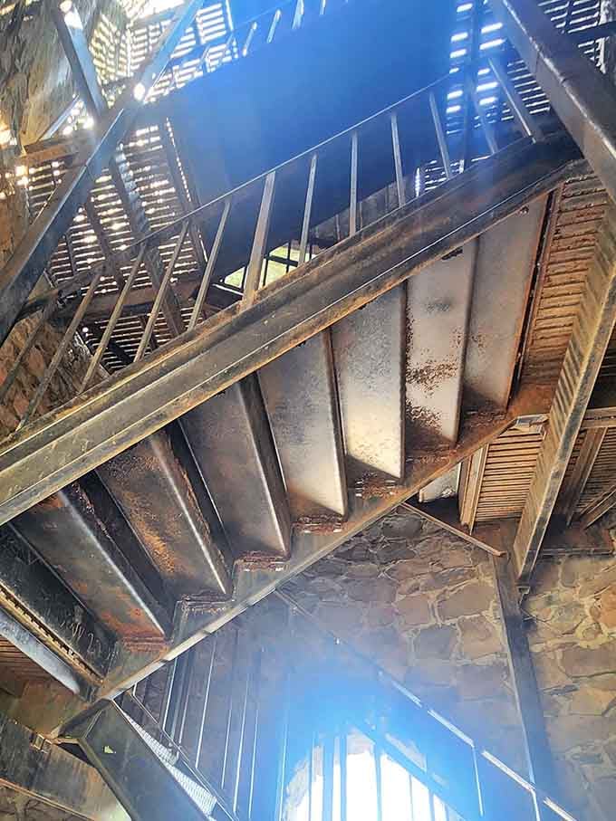 The spiral staircase winds upward like a metal ribbon, promising spectacular views for those who climb.