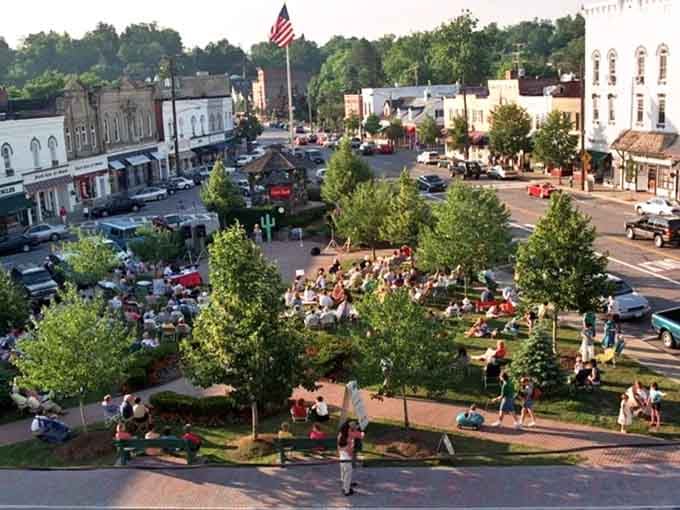 Triangle Park becomes the community's living room where neighbors gather, kids play, and that waterfall provides the soundtrack.