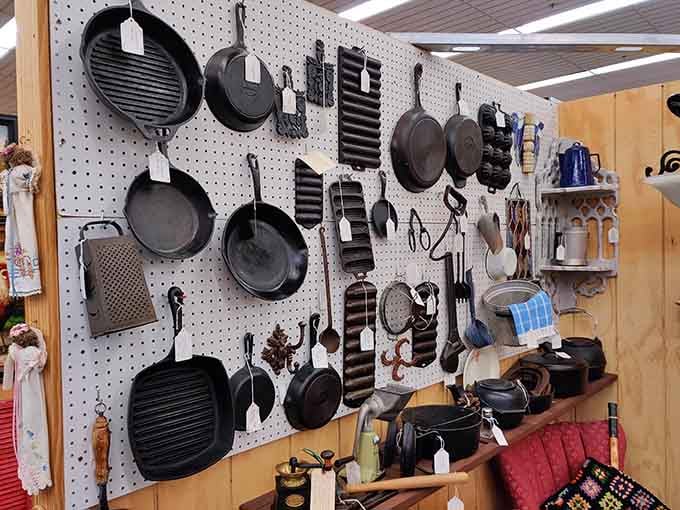 Cast iron cookware that's outlasted relationships, careers, and probably a few kitchen renovations hangs ready for its next chapter.