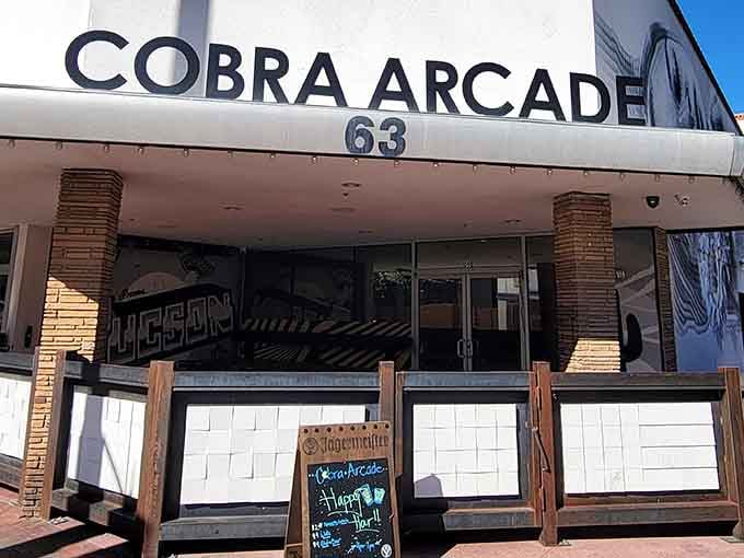 The Cobra Arcade Bar storefront beckons like a neon siren call to your inner teenager who never grew up.