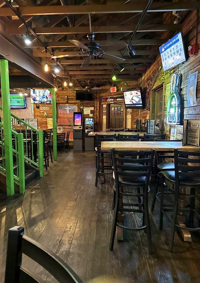 Wood beams, green accents, and multiple TVs create the perfect treehouse for grown-ups who never grew up.