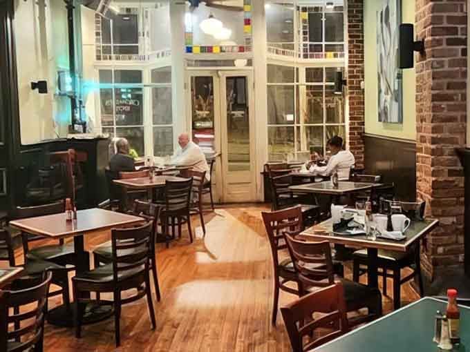 Exposed brick and warm wood create an atmosphere that whispers "stay awhile" louder than most restaurants shout it.