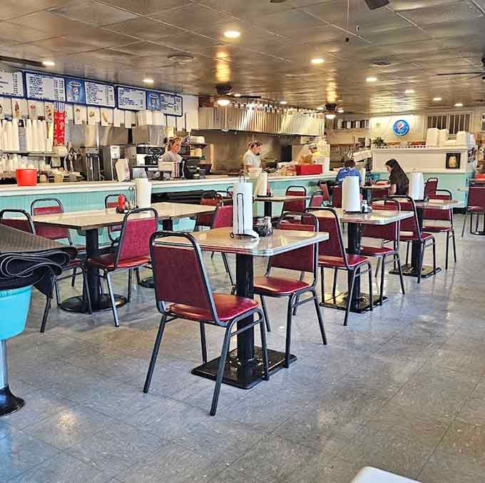 Classic diner seating with that turquoise counter where countless conversations have unfolded over coffee and pie.