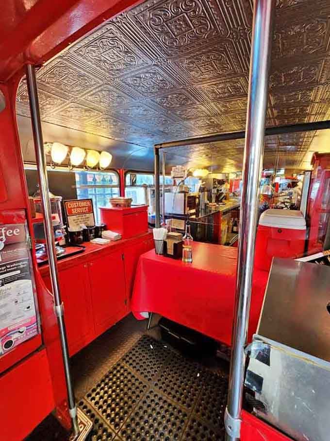 Step inside where vintage bus charm meets modern caf&eacute; culture, complete with gleaming tin ceilings and cozy red seating.