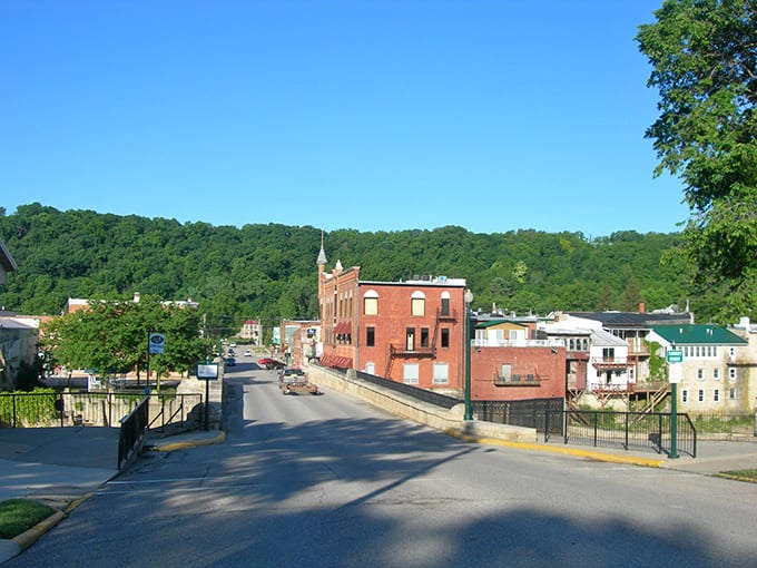 The iconic Keystone Bridge welcomes visitors to downtown Elkader, where brick buildings stand shoulder to shoulder like old friends sharing stories across generations.