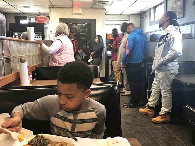 The line snakes through like opening night at a blockbuster, except everyone's here for oxtails instead of superheroes.
