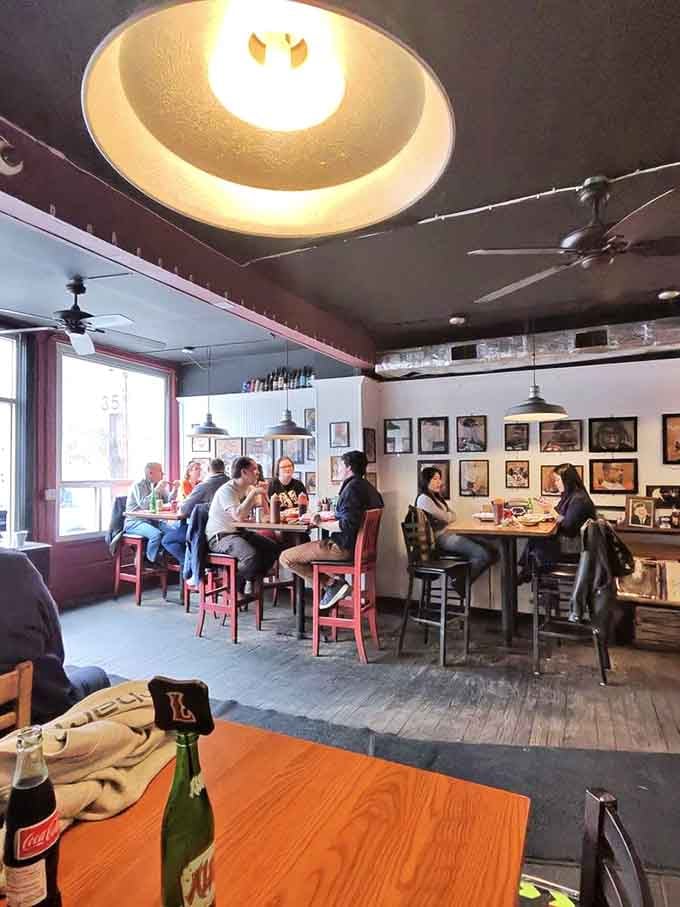 Inside, mismatched chairs and framed photos create that perfect "your cool uncle's basement" vibe everyone craves.