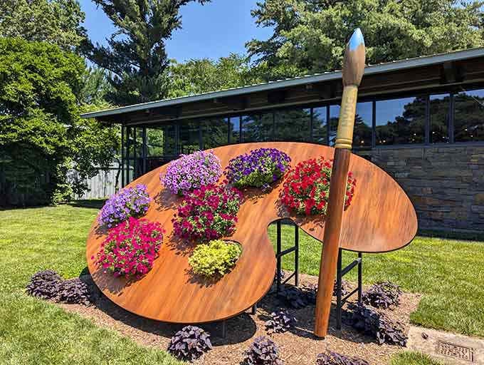 Bright flowers transform this oversized wooden palette into a living masterpiece, inviting you to imagine painting with nature&rsquo;s own vibrant colors.