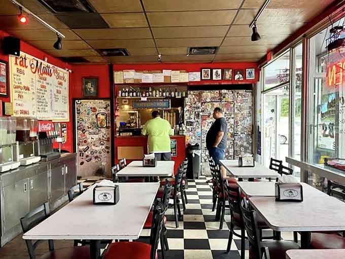The black and white checkered floor and red walls create a classic diner vibe that feels refreshingly honest.