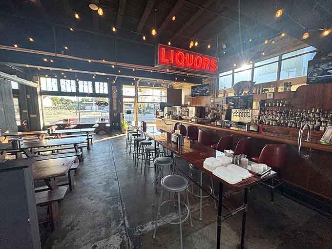 Industrial meets inviting, where string lights and that glowing LIQUORS sign set the perfect mood for smoked meat.