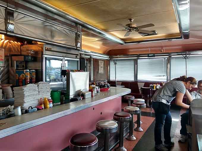 Classic counter seating where locals gather like it's the most important meeting of the day, because it is.
