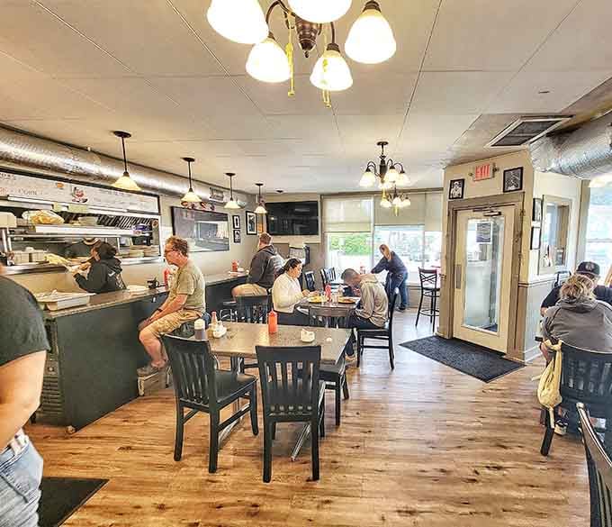 Simple tables, pendant lights, and an open kitchen&mdash;this is where comfort food happens in real time, no pretense required.