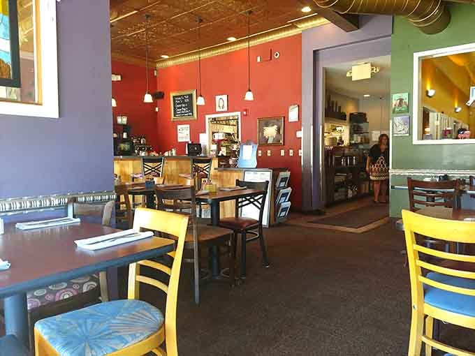 Colorful walls and mismatched chairs create the kind of cozy chaos where great breakfast memories are born.