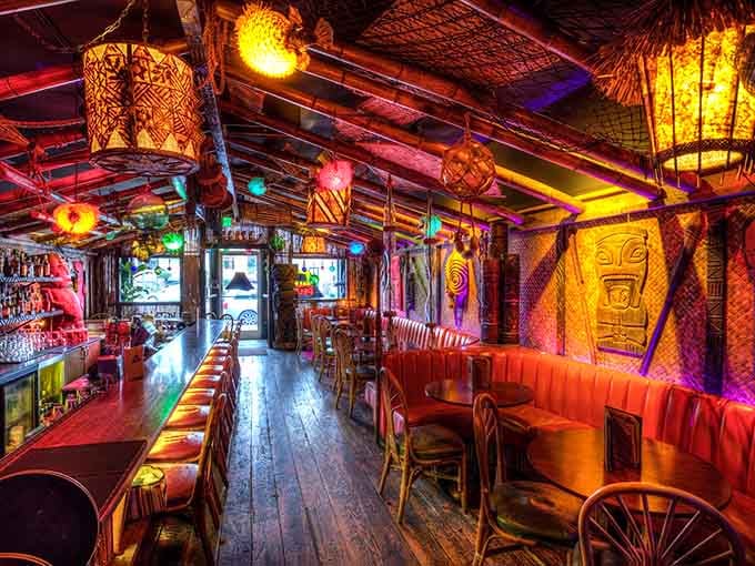 Every inch of this place screams tropical paradise, from the carved tikis to the glowing lanterns overhead.