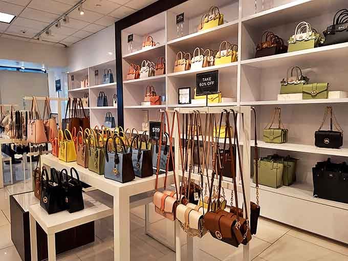 Handbag heaven! A rainbow of designer purses standing at attention like fashionable soldiers ready for their marching orders.